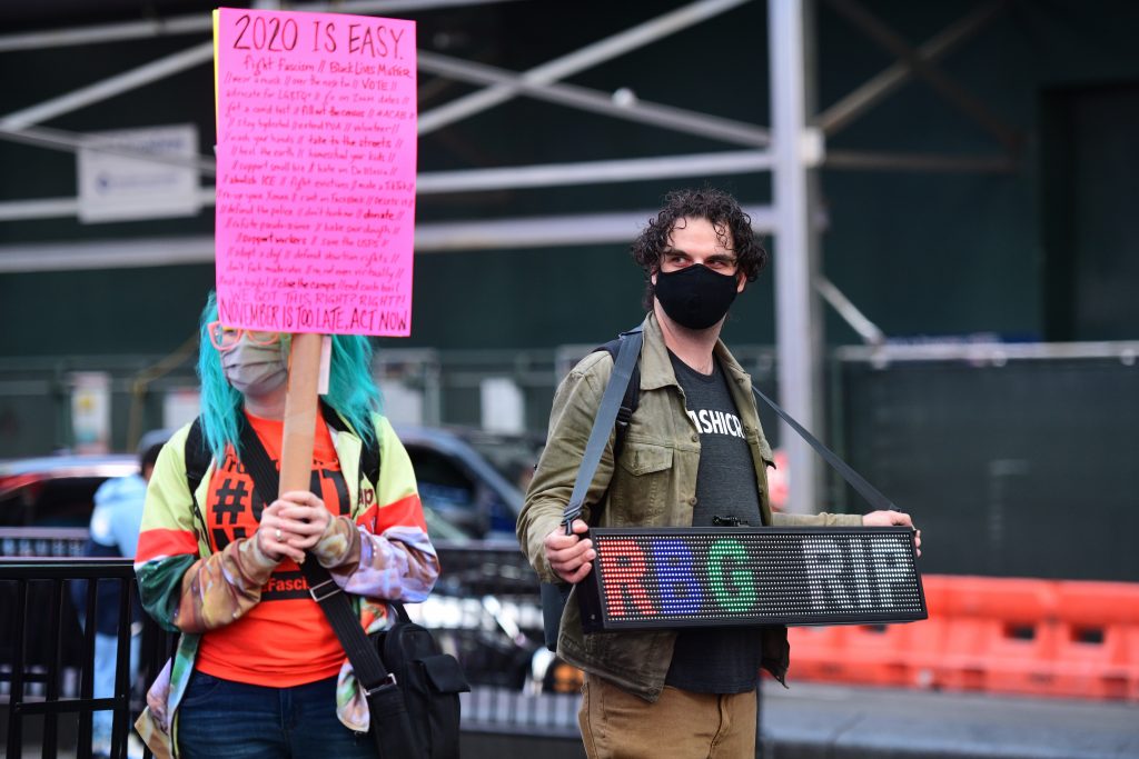 ‘We must rise now’: Times Square rally highlights 200,000 deaths from ...