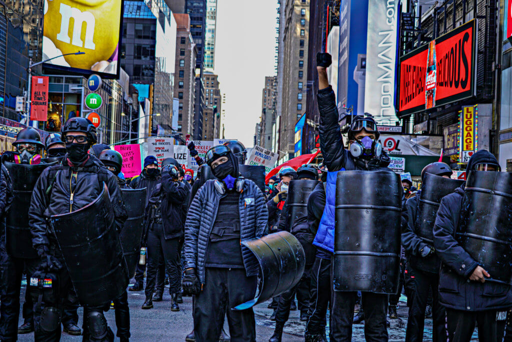 Counter protesters don body armor in anticipation of MAGA march in ...