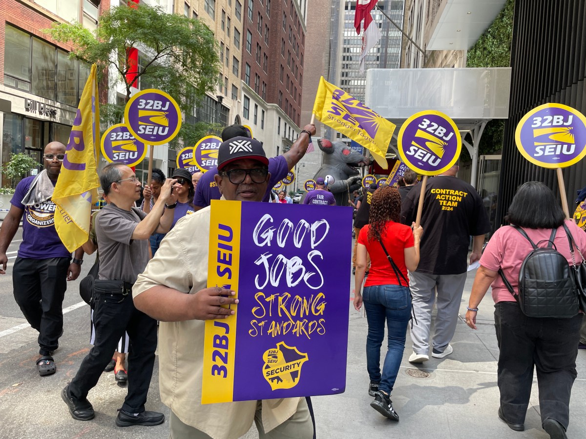 Union members protest firings and wage cuts in Midtown